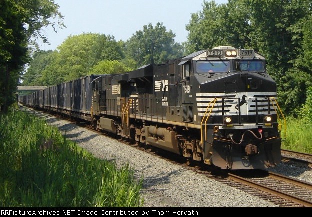 NS 7519 heads up a train of empty municipal waste containers